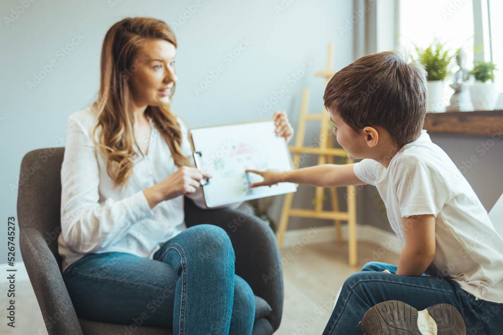 Child psychologist working with kid boy in office. Young Boy With ...