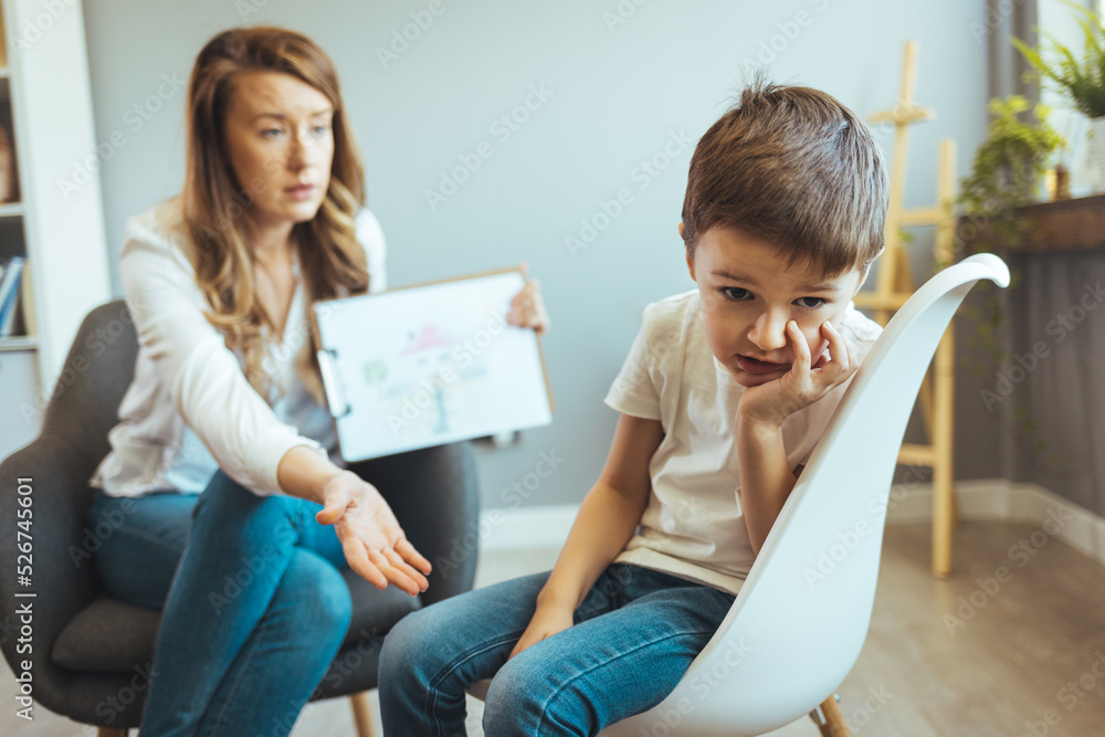 Young Boy Talking With Counselor At Home. Female psychologist working ...