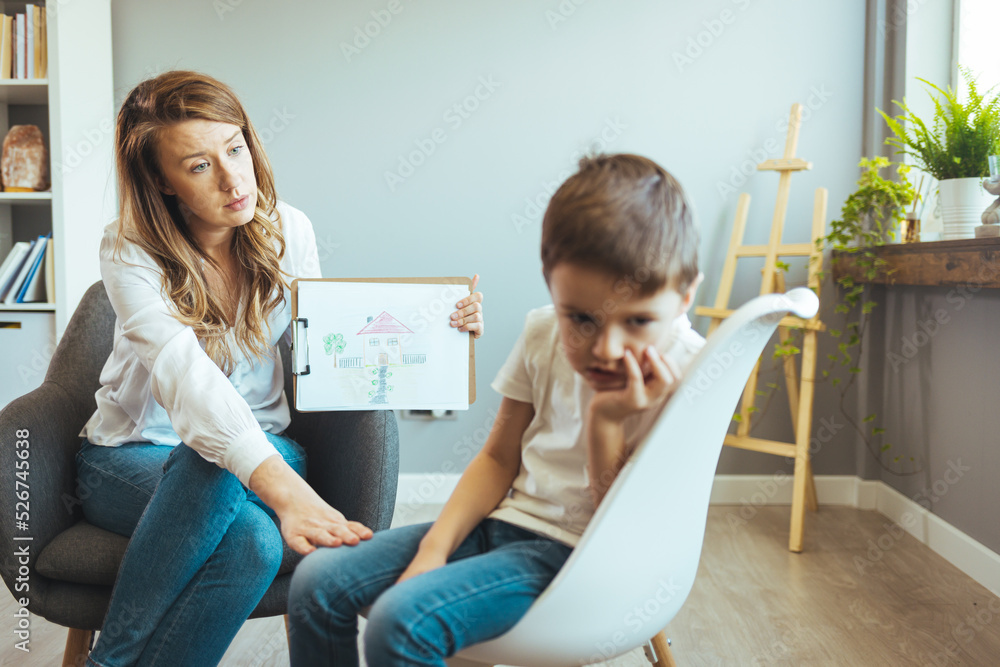 Young Boy Talking With Counselor At Home. Female psychologist working ...