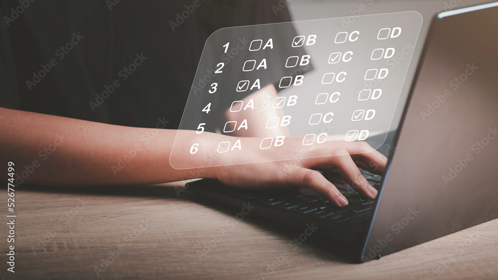 Students taking online exams by laptop. Virtual test or questionnaire ...