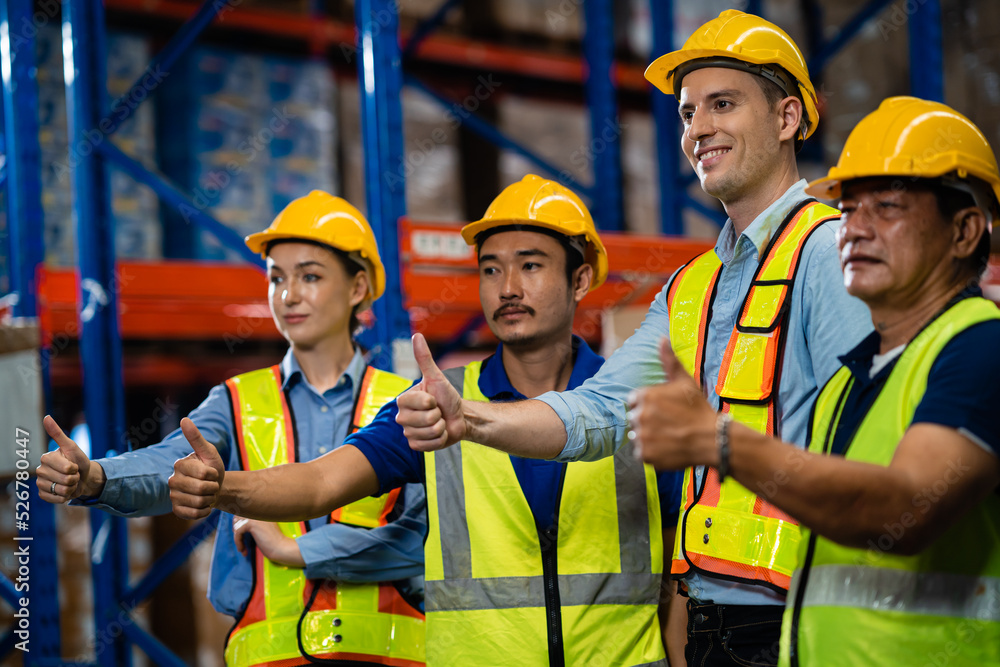A group of workers standing in a warehouse. Logistics work. Freight and ...