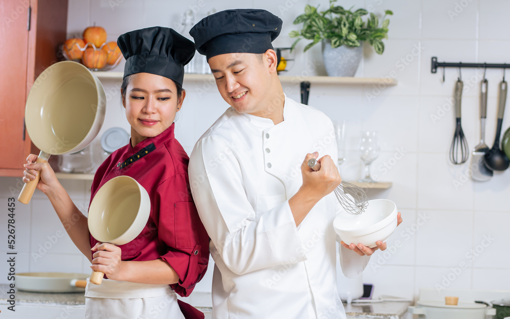 Portrait two young adult Asian professional couple chefs wearing ...