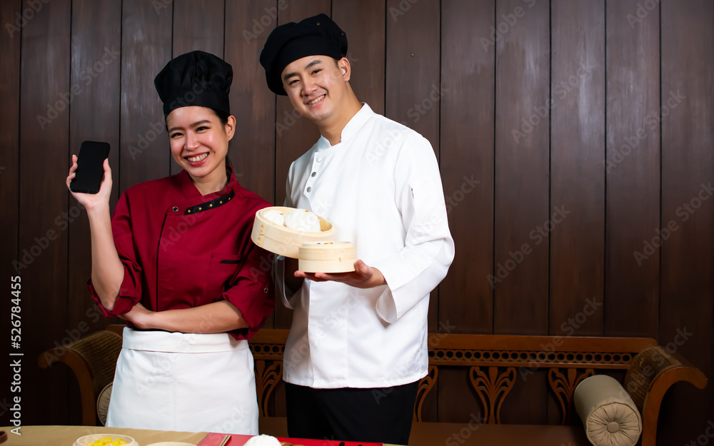 Two traditional professional Chinese chefs wearing uniform, hat ...