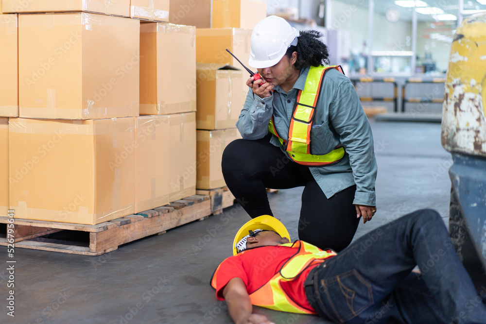 Warehouse worker lying down on floor after having accident from working ...