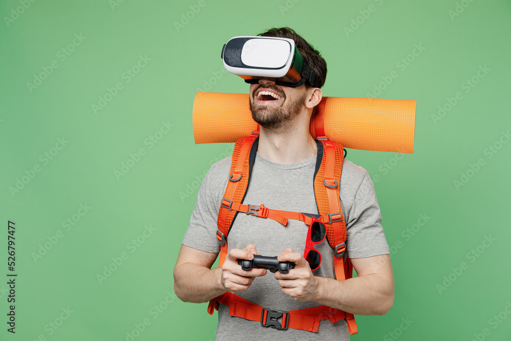 Young traveler white man carry backpack stuff mat watch in vr headset ...