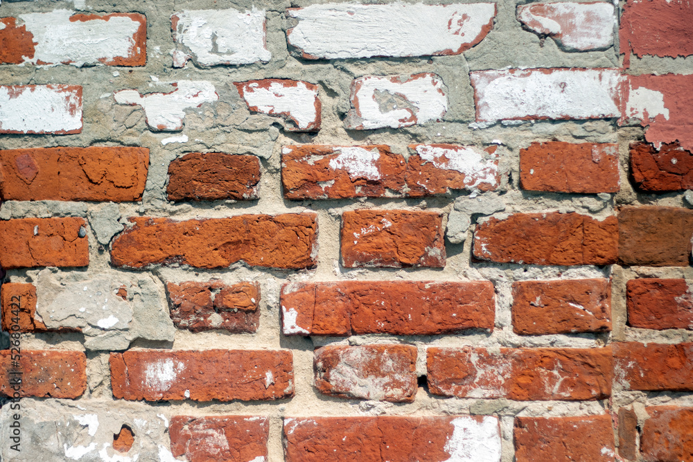 Fragment of old brickwork, close-up plan. A wall of red brick. Potholes ...