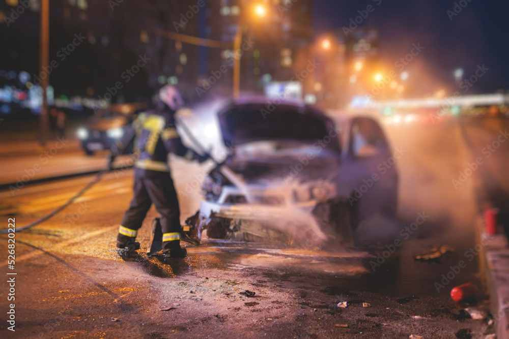 Group of fire men extinguishing and put out burning car crash after ...