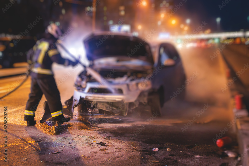 Foto Stock Group of fire men extinguishing and put out burning car ...