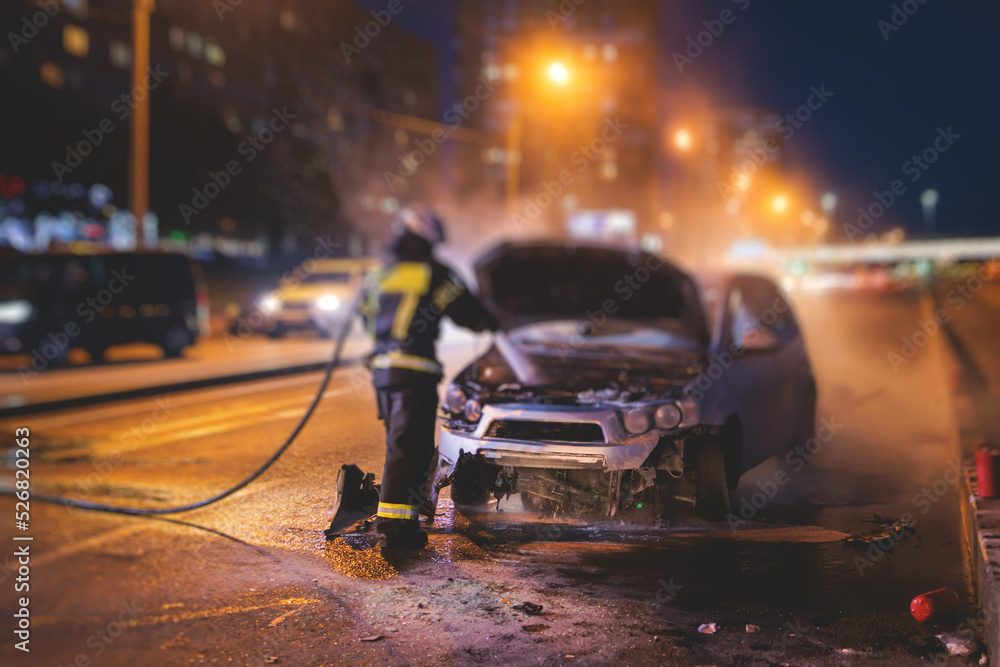 Group of fire men extinguishing and put out burning car crash after ...