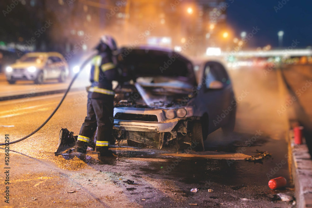 Group of fire men extinguishing and put out burning car crash after ...