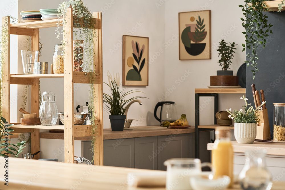 Horizontal image of modern domestic kitchen with paintings on the wall ...