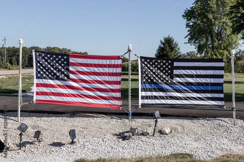 American flag alongside a Thin Blue Line flag honoring the US and Law ...