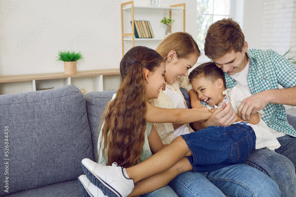 Cheerful family with children having fun together and fooling around ...