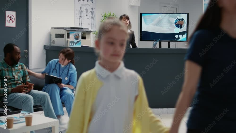 Diverse group of people in busy waiting room lobby with reception desk ...