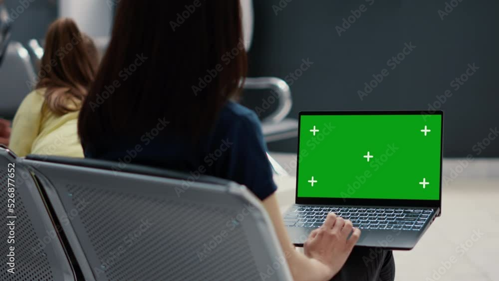 Mother and small kid holding laptop with greenscreen background in ...