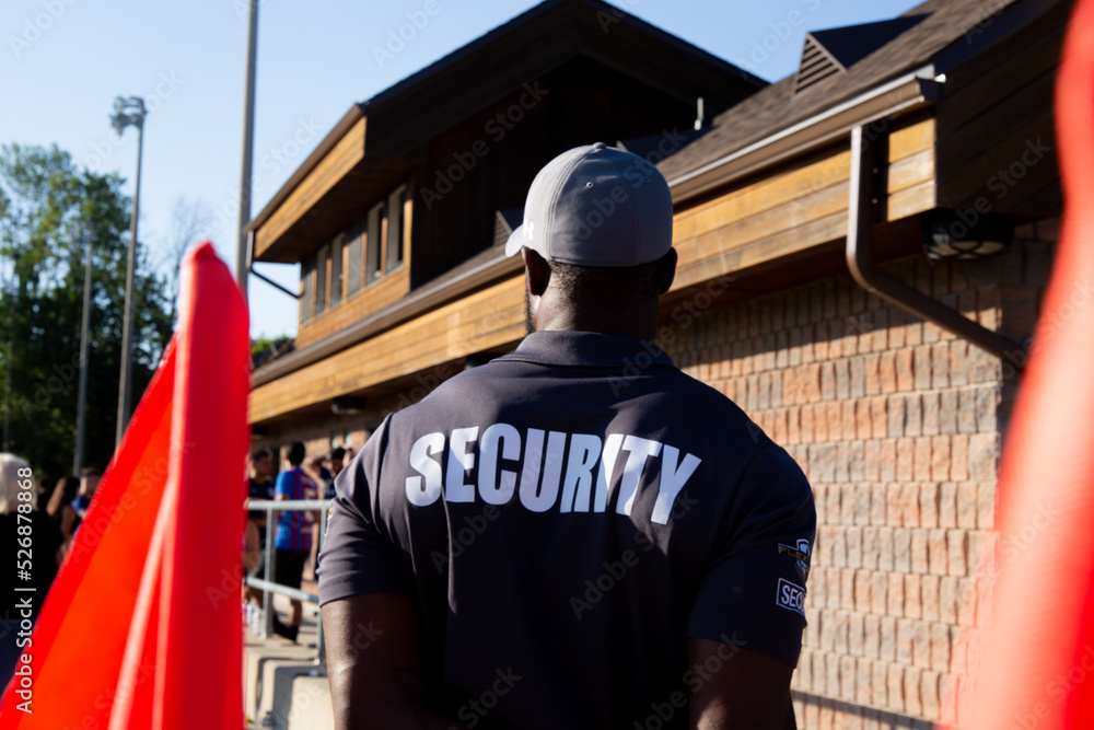 Security guard patrolling soccer stadium Stock Photo | Adobe Stock