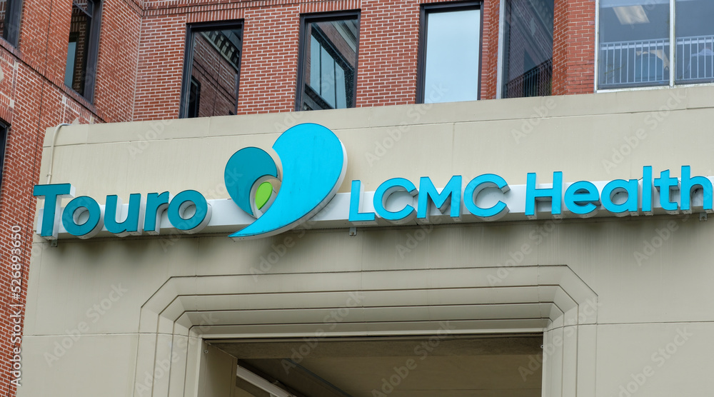 Front of historic Touro Hospital with Touro LCMC Health sign over ...