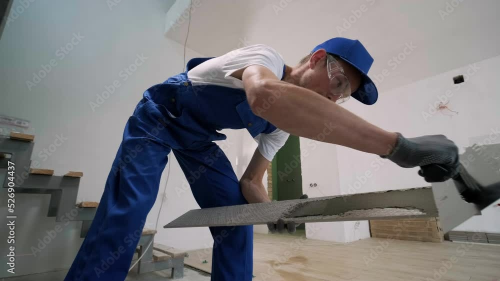 Installing ceramic floor tiles - measuring and cutting the pieces ...