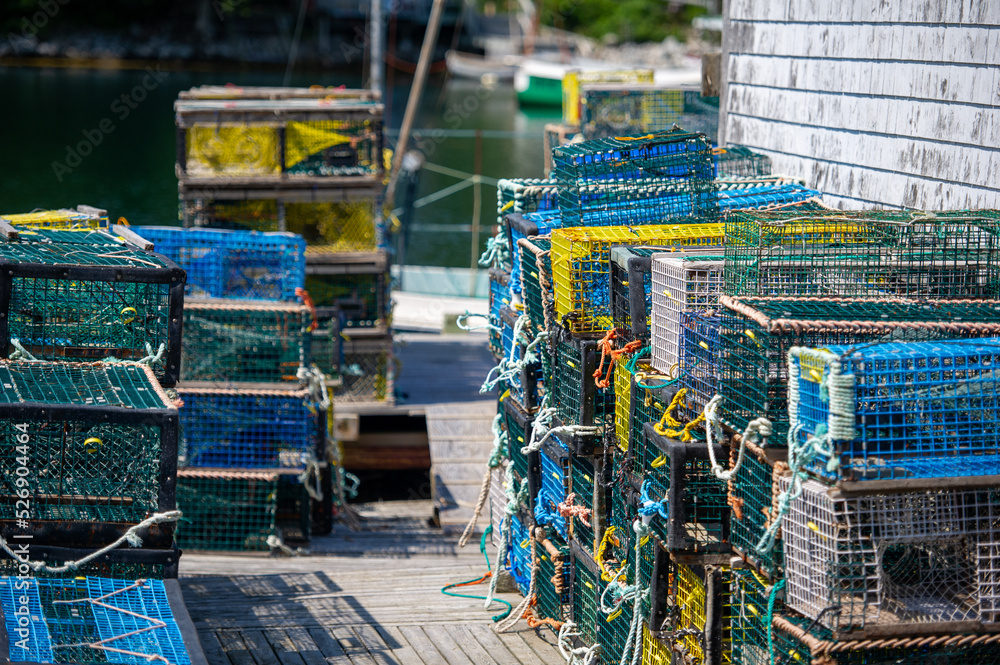 Colorful lobster traps lined up on the wooden dock near Peggy's Cove ...