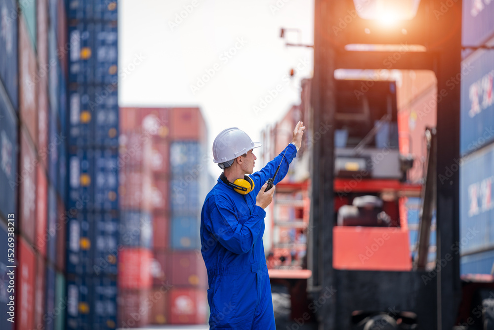 Supervisor dock cargo checking and control loading Containers box at ...