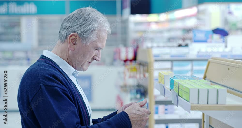 Senior man check pills on a shelf of a pharmacy for medical drugs and ...