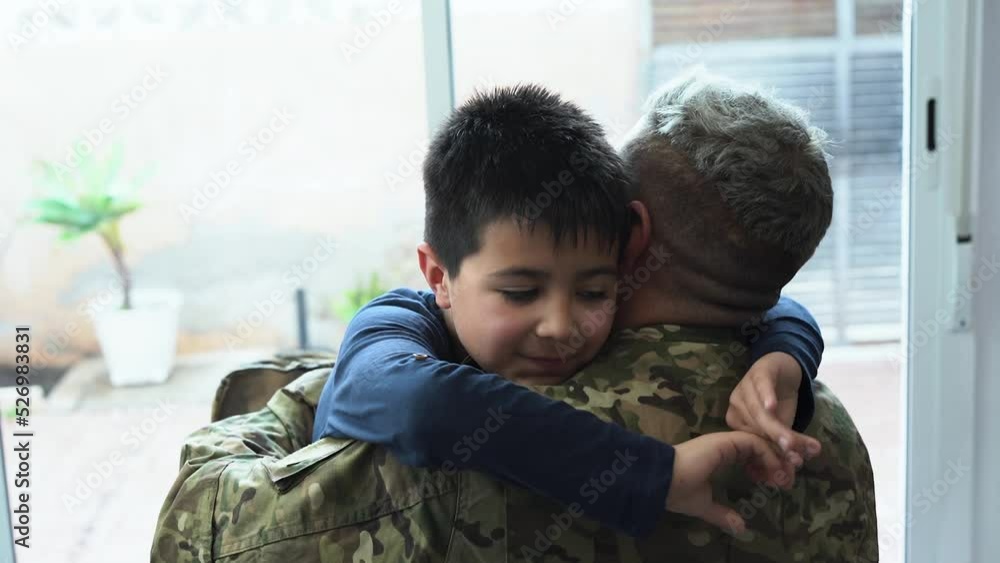 Military soldier man hugging his son at home - Father and child love ...