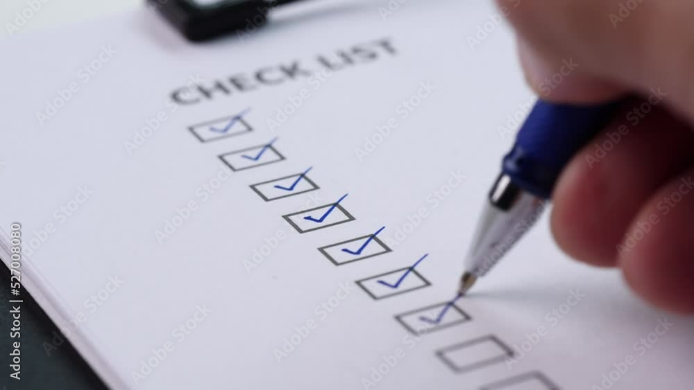 Extreme close up businessman hand marking or tick off with blue pen on ...