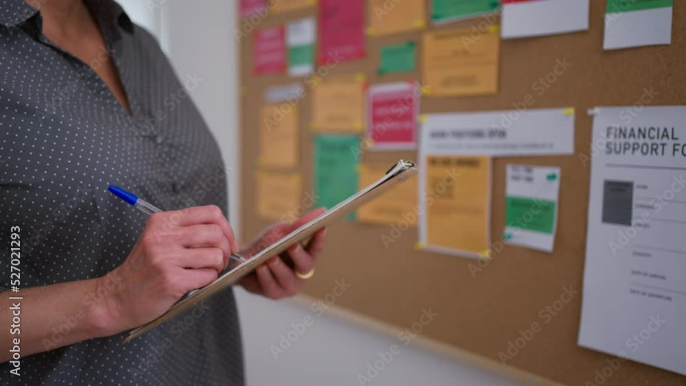 Job center employee with file form standing in front of employment ...