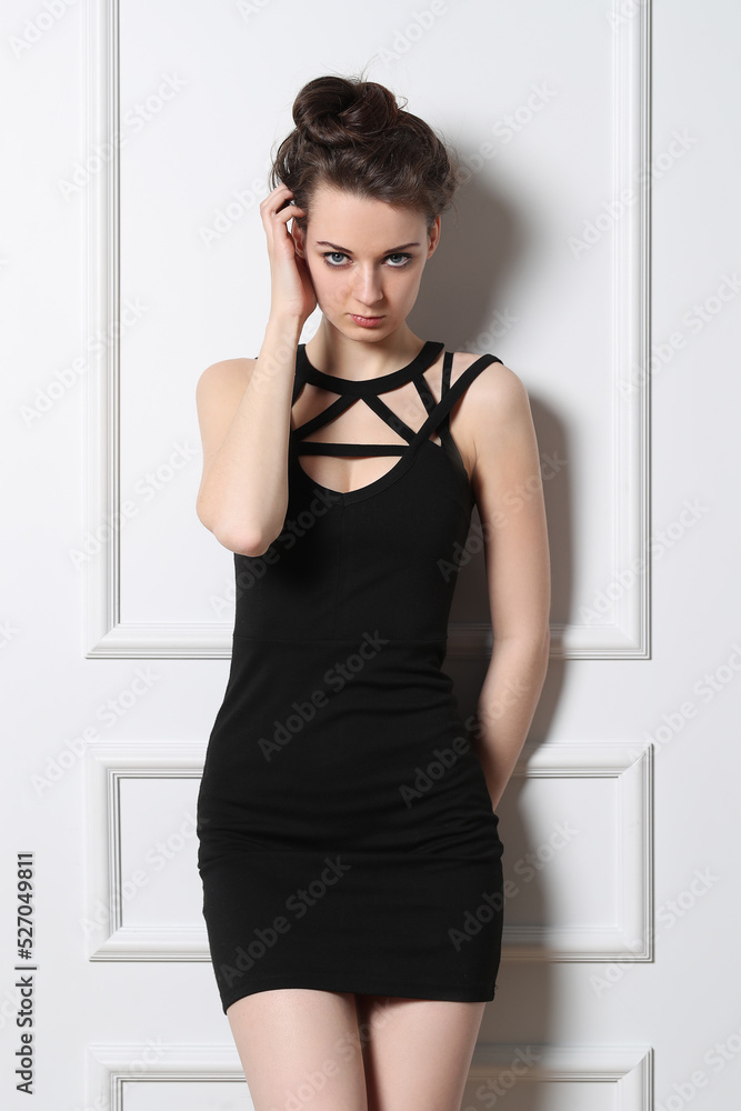 This captivating dark-haired model emanates confidence and poise as she ...