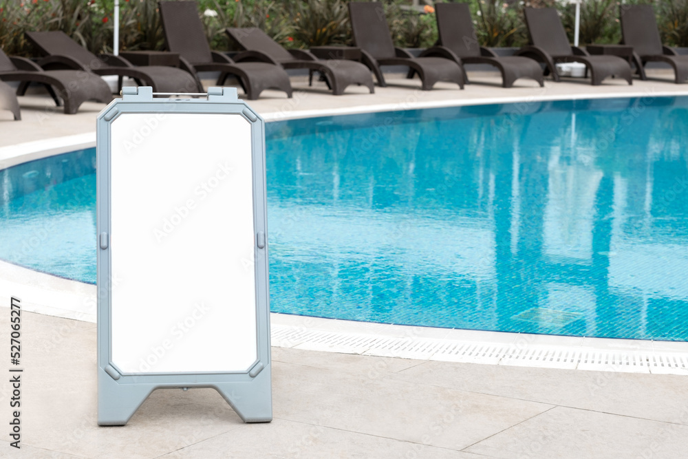 Empty swimming pool with blue transparent water, no people. Warning ...