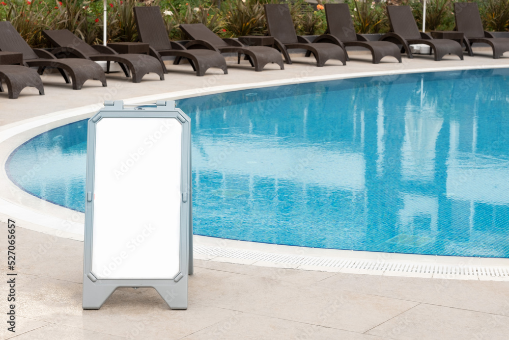 Empty swimming pool with blue transparent water, no people. Warning ...