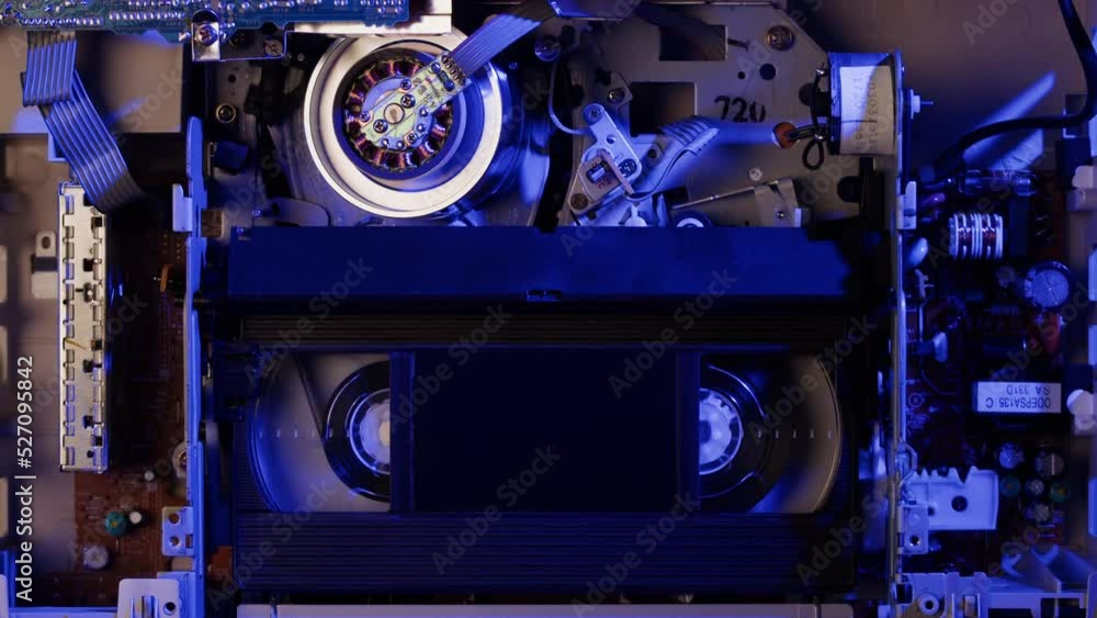 Old video recorder inside close-up, VHS. Retro player in neon blue ...