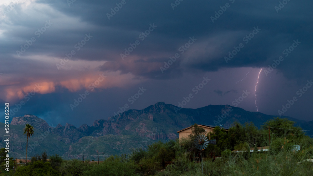 Lightning bolt and monsoon storm clouds over the Catalina Mountains in the Sonoran Desert north ...