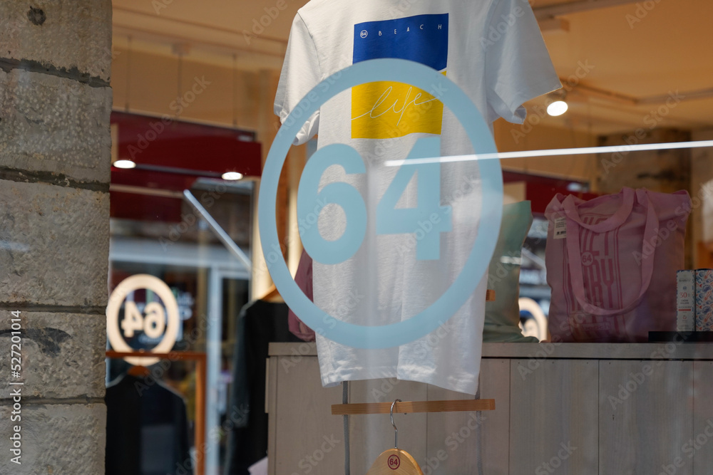 64 logo sign and brand text on windows store facade clothing shop ...