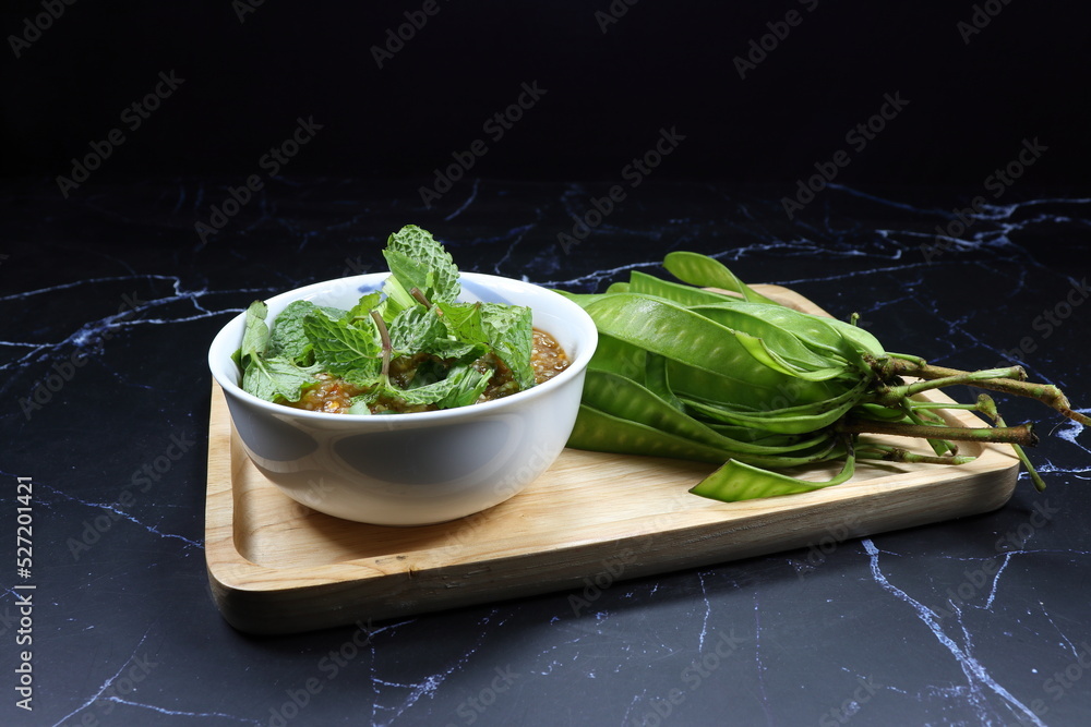 Pile of fresh river tamarind (Leucaena leucocephala) serving with spicy ...