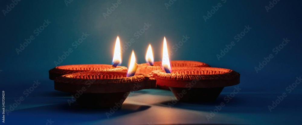 Diwali, Deepavali Hindu festival of lights. Diya lamp lit on blue ...