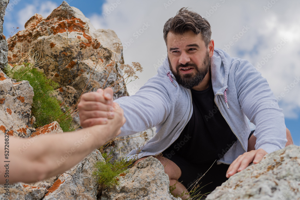 Hiking team helping each other friend giving a helping hand while ...
