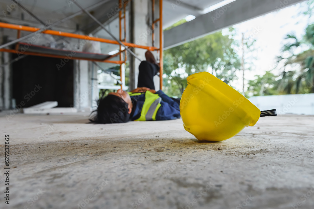 Yellow hard hat from construction worker accident falls from ...