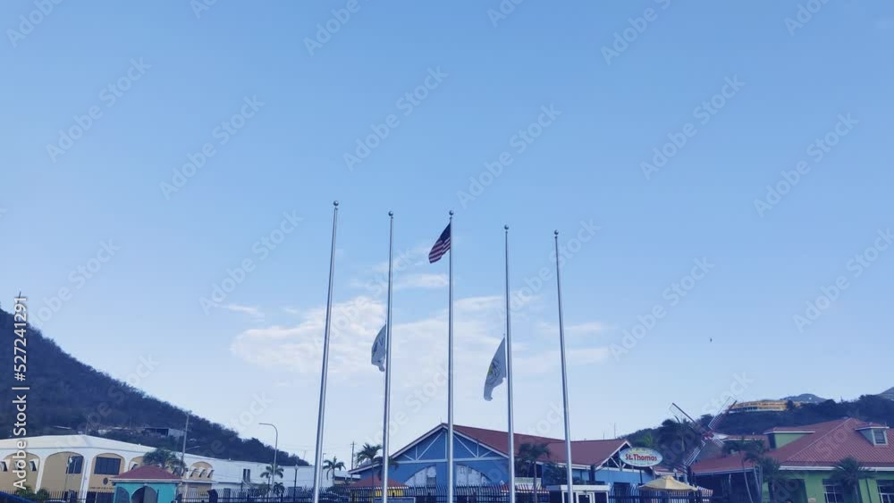 Flag of St Thomas Virgin Island and USA waving on poll on Port of St ...
