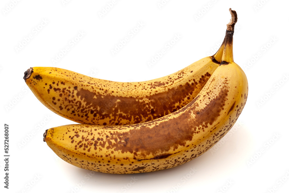 Two wrinkled old bananas with brown spots isolated on white background ...