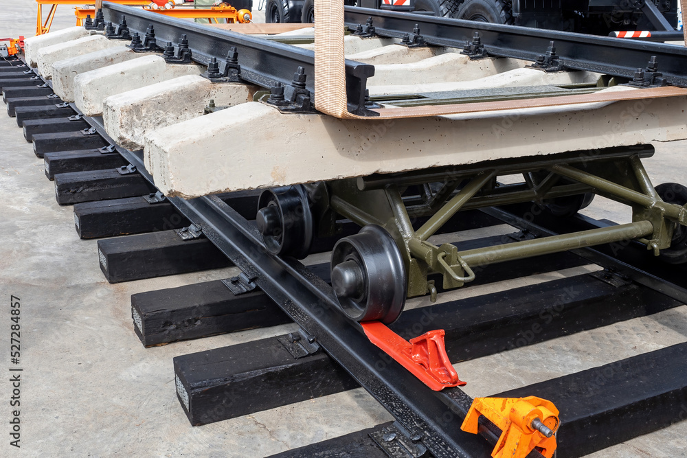 Rail laying equipment. Trolley with concrete sleepers on rails. Concept ...