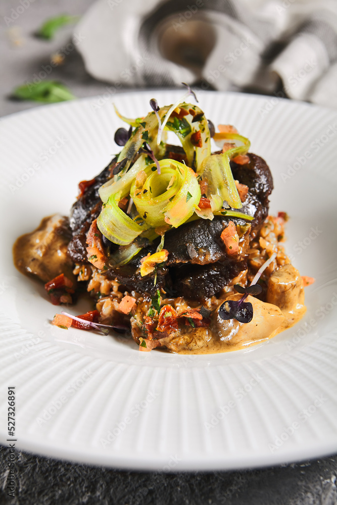 Braised beef cheeks with pearl barley and celery in creamy mushroom ...