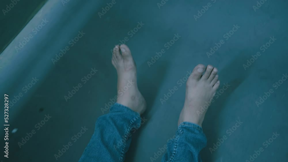 Man walks up to corpse of woman and drags body by legs from room ...