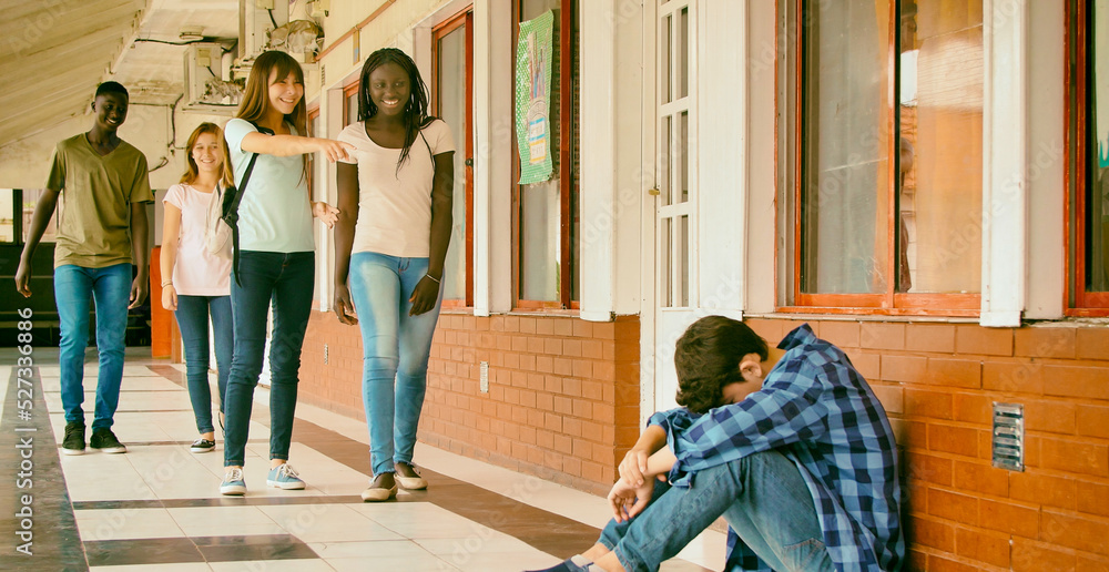 Young caucasian sitting alone with sad feeling at school. Child in ...