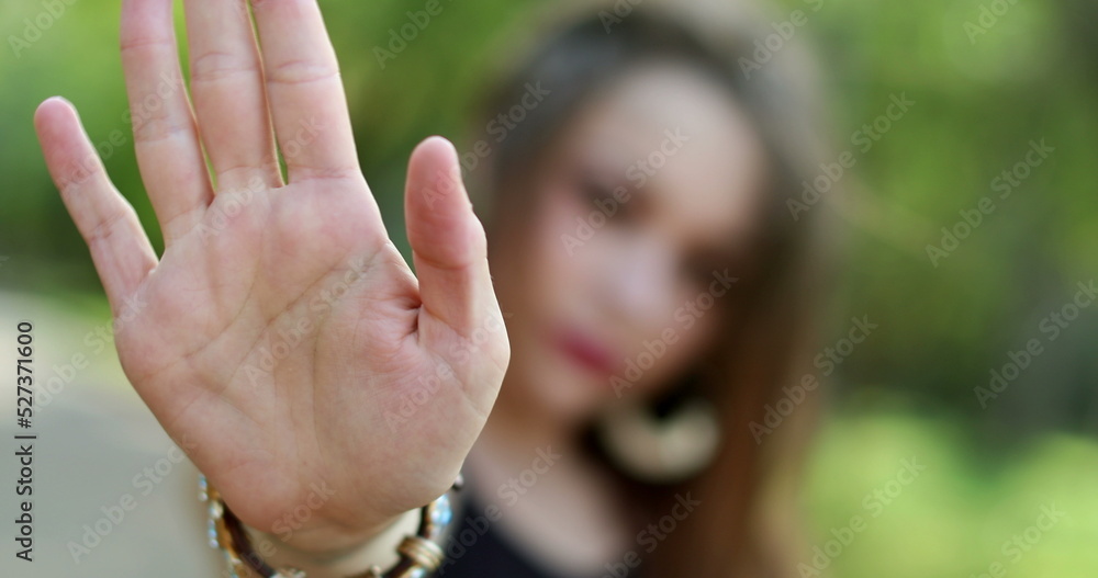 Young attractive woman blocking with hand. Pretty girl signalling to ...