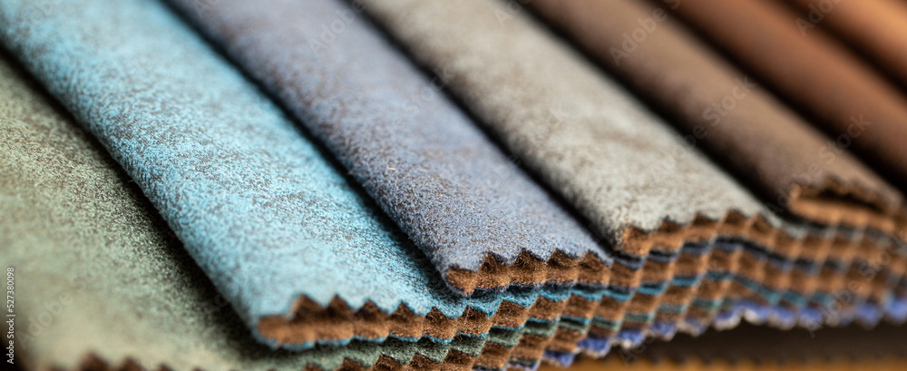 Fabric swatches in different colors are stacked for selection. A ...