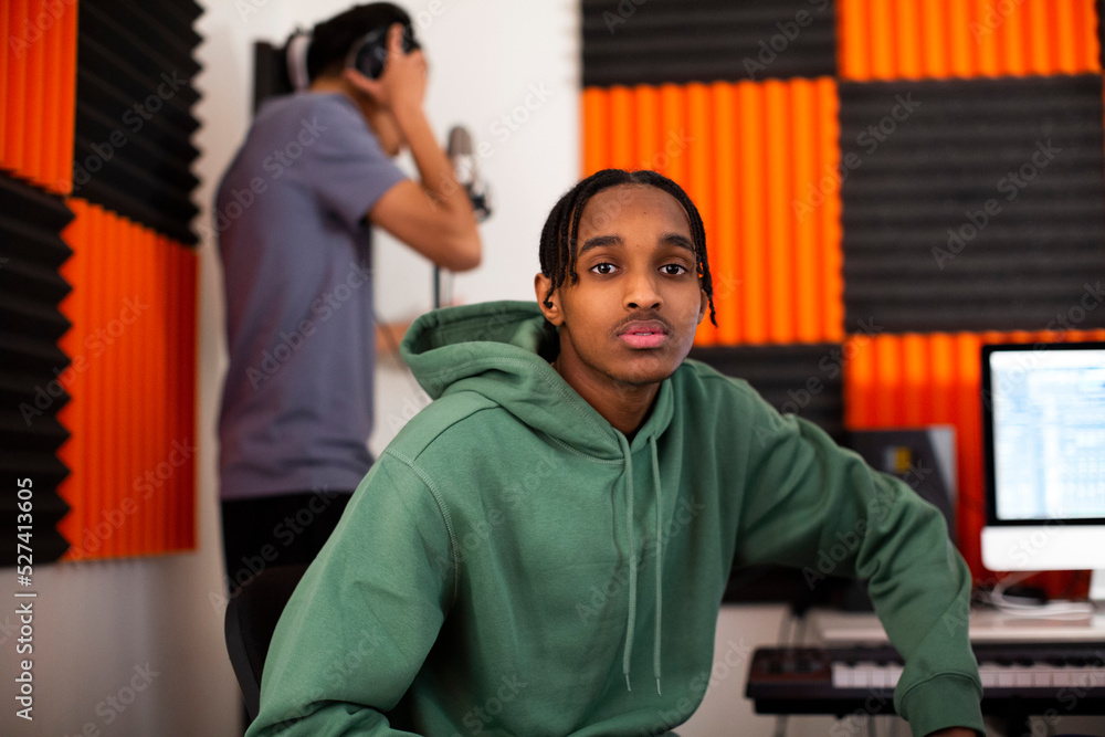 Teenage boy with dreads sitting in recording studio Stock Photo | Adobe ...