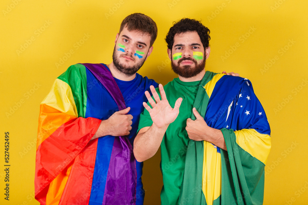 couple of men, brazilian, soccer fans from brazil, wearing LGBT flag ...