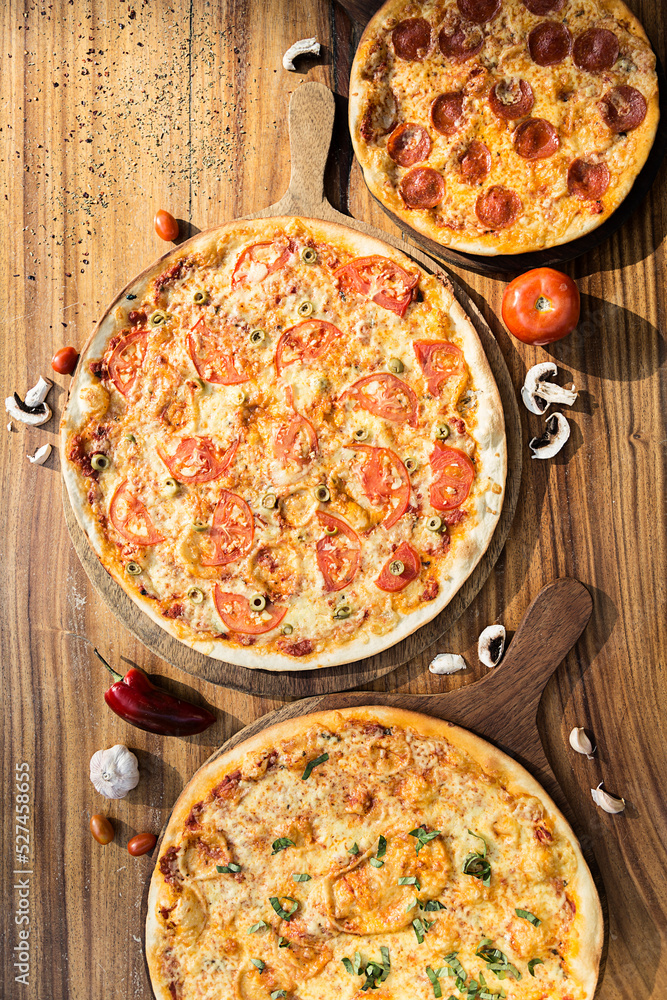 Three pizzas of different flavors. Pepperoni, cheese, potato, onion ...