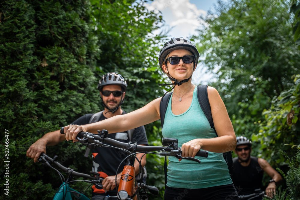 Foto de woman and man caucasian friends ride electric bicycle e-bike in ...